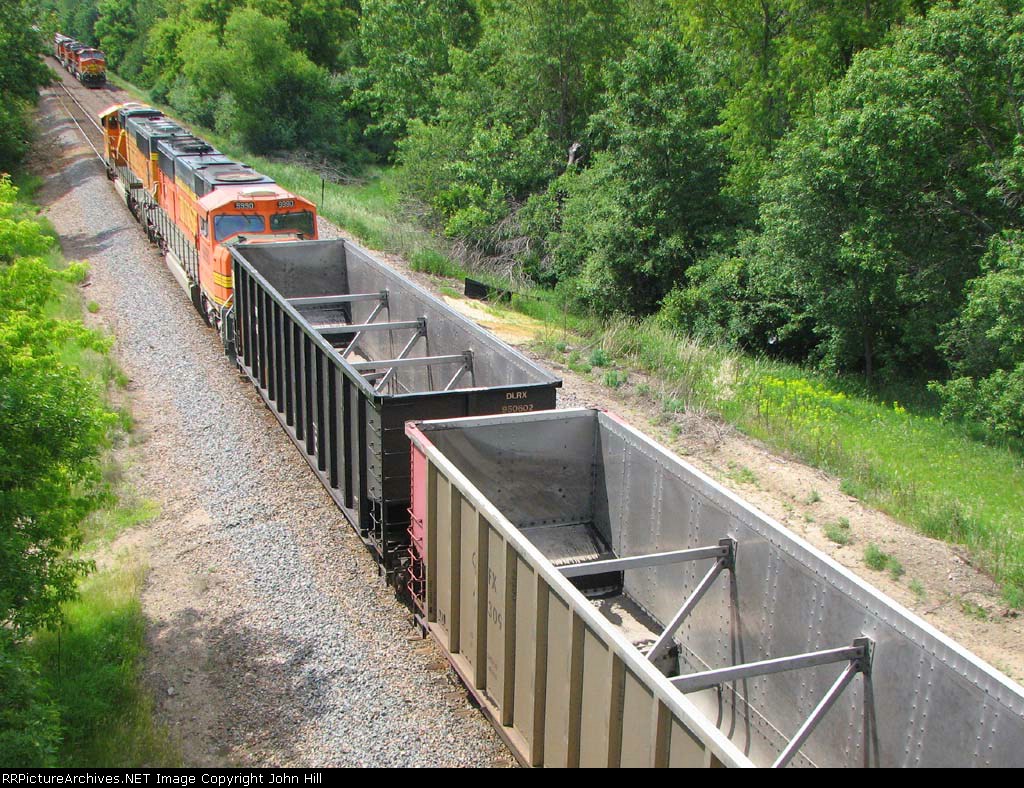 090614002 Westbound DEEX coal empties on main meet eastbound BNSF manifest in siding on Wayzata Sub.